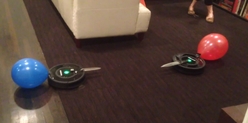 Watch 2 Roombas With Knives Battle to Death